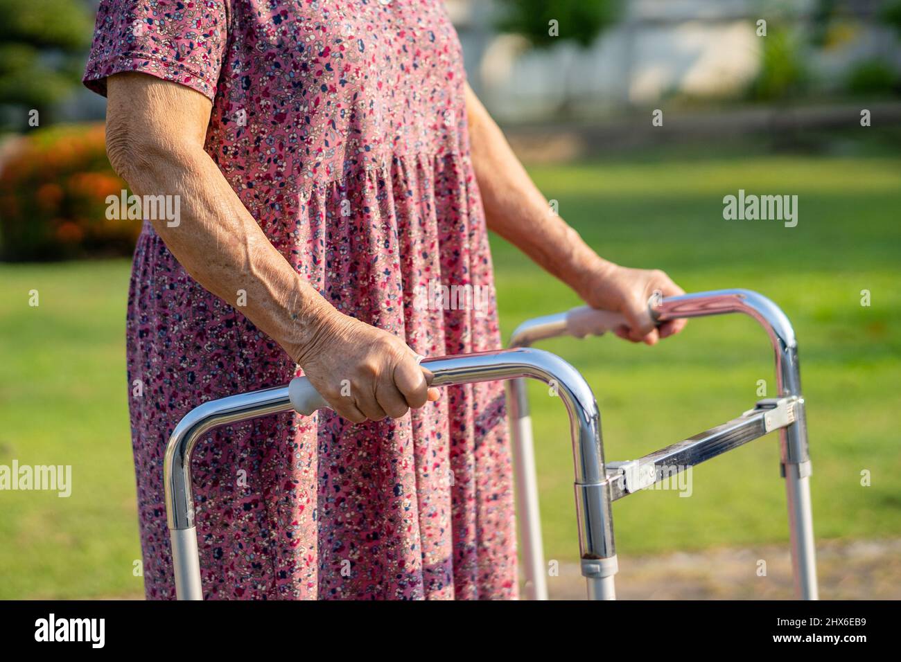 Asian senior or elderly old lady woman use walker with strong health ...