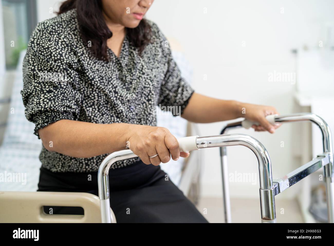 Asian lady patient pain her back wrist orthopedic lumbar with walker ...