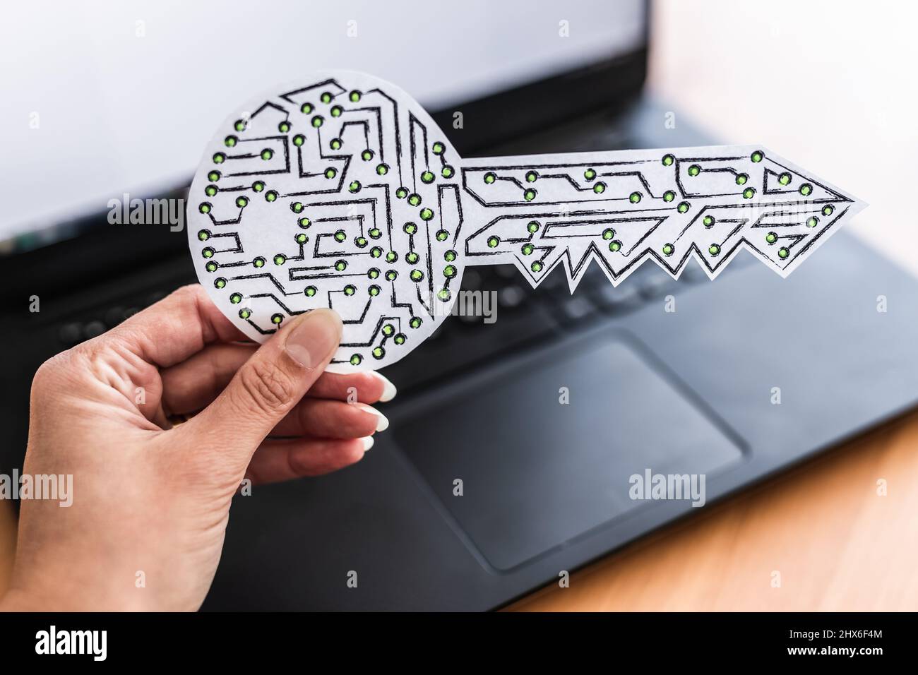 hand holding encryption key icon made of circuits and LED lights in ...