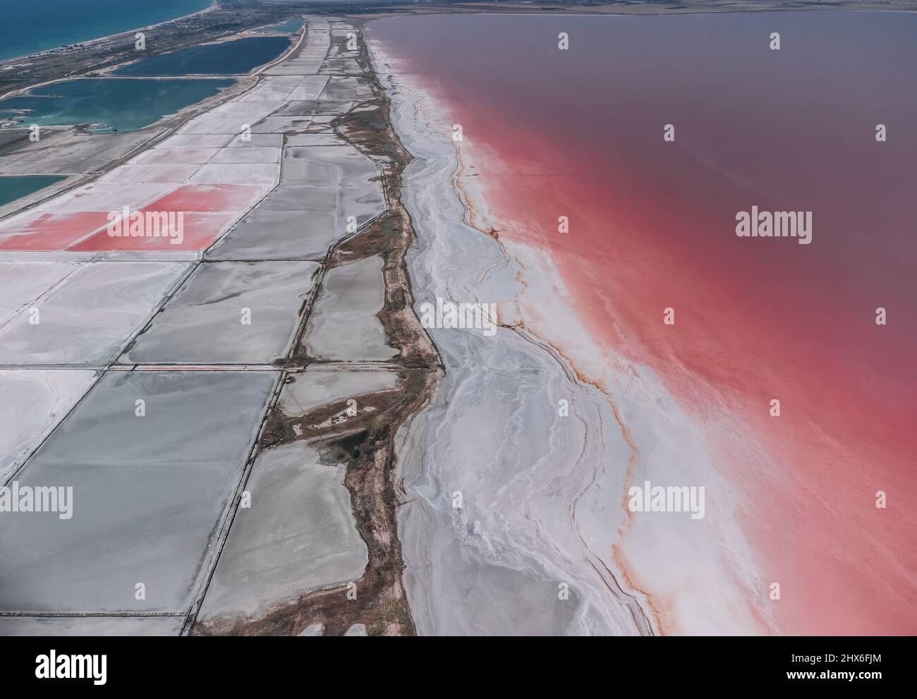 Flying over a pink salt lake. Salt production facilities saline ...