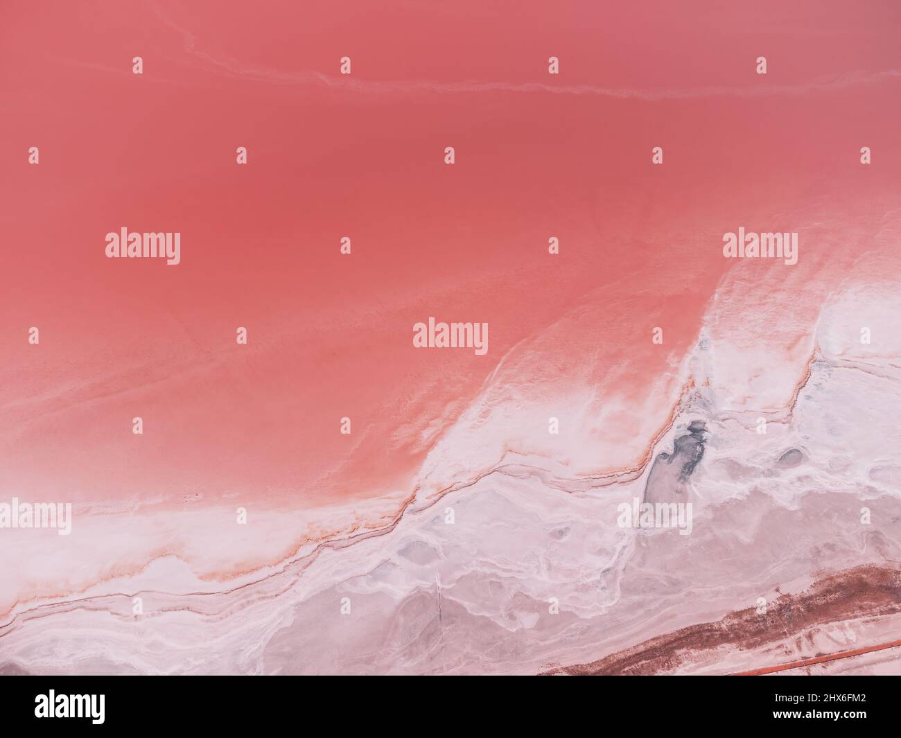 Flying over a pink salt lake. Salt production facilities saline ...
