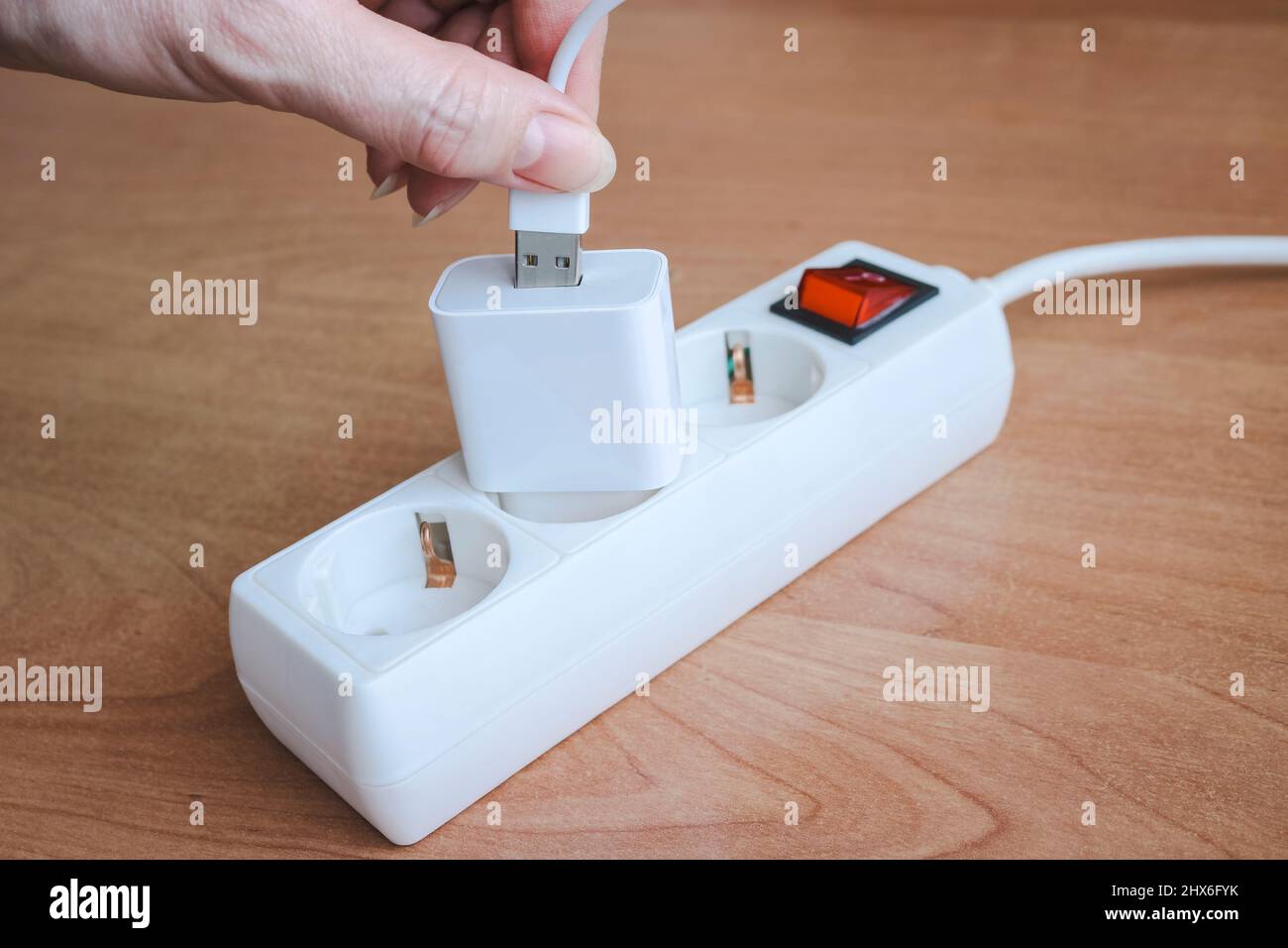 Woman plugging cable modern smartphone hi-res stock photography and ...