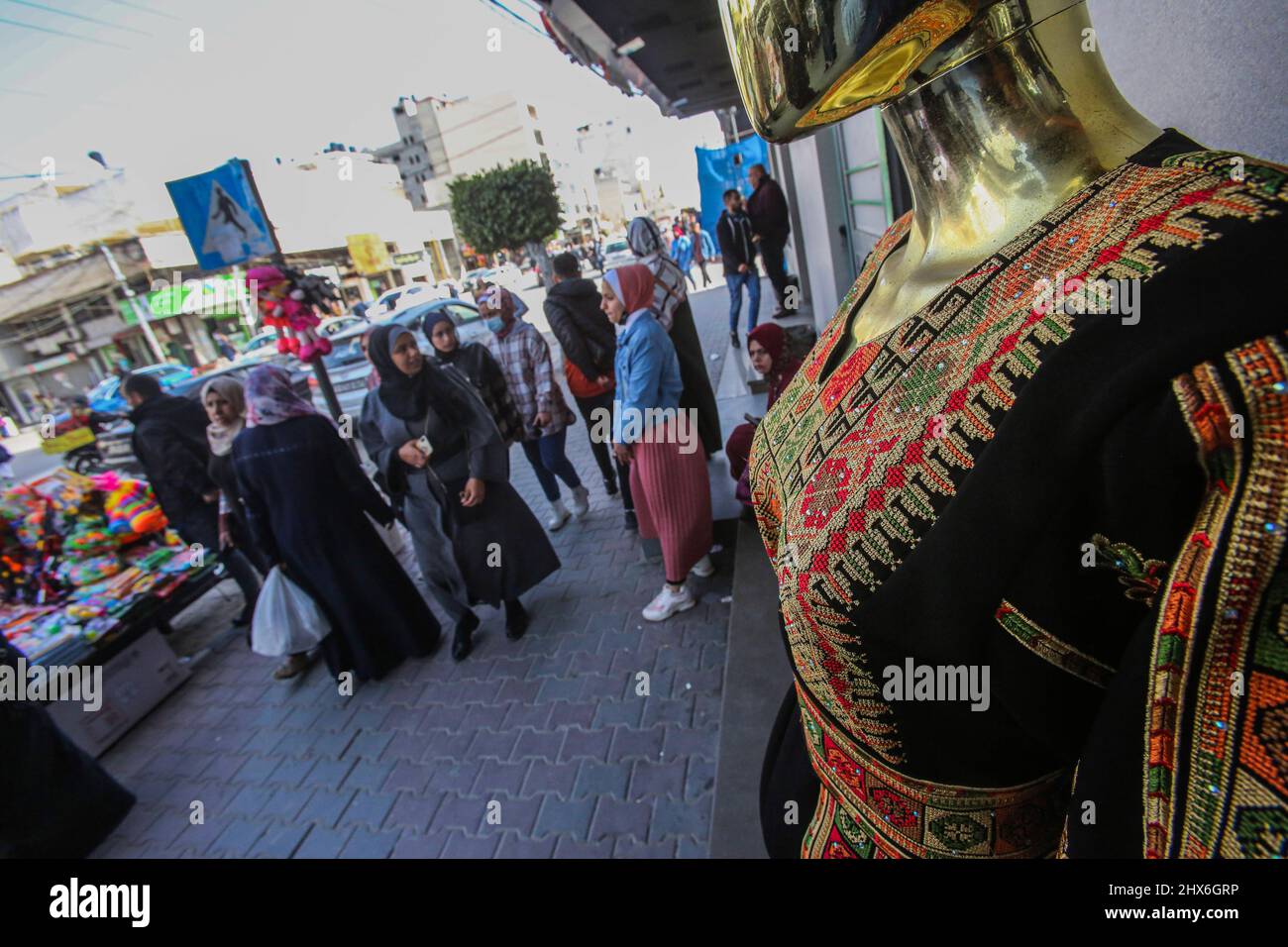 Gaza, Palestine. 09th Mar, 2022. Palestinians walk past a Palestinian ...