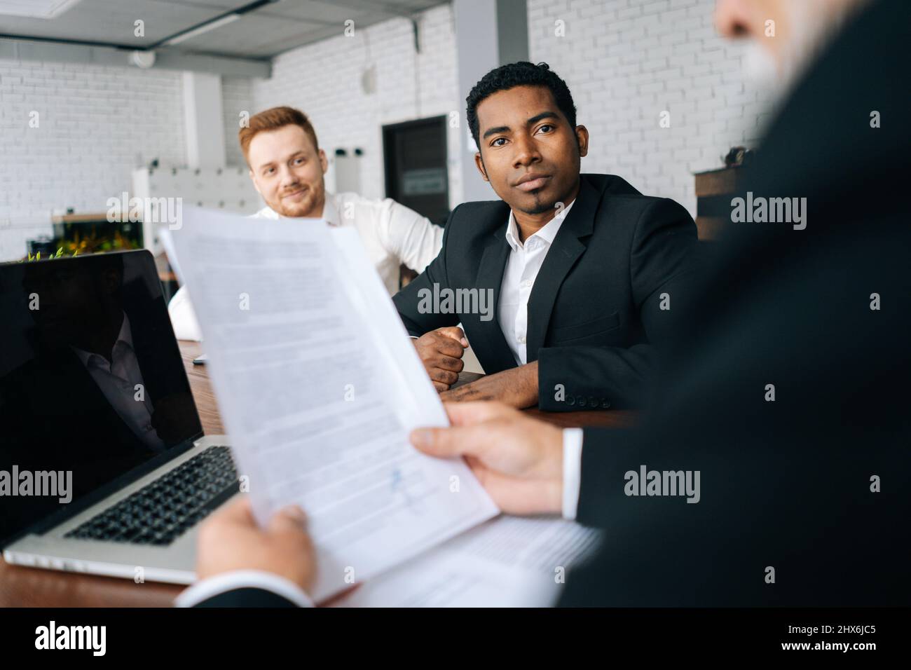 Close-up view from back of mature adult business man sitting at desk ...