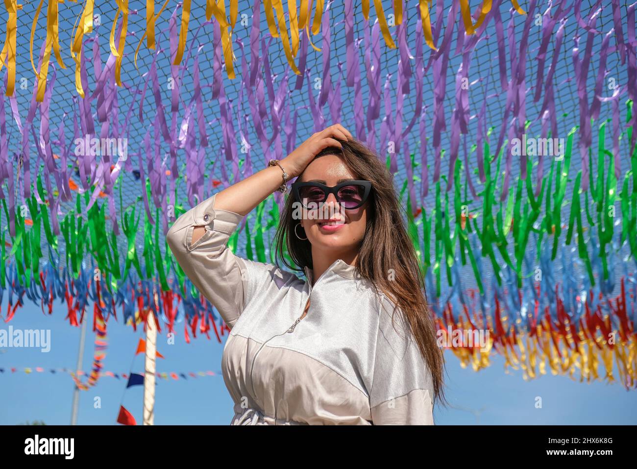 Young woman sitting on festival. Gen z girl enjoying outdoors ...