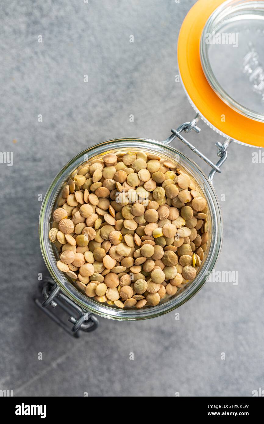 Uncooked brown lentils. Raw legume in jar. Top view Stock Photo - Alamy