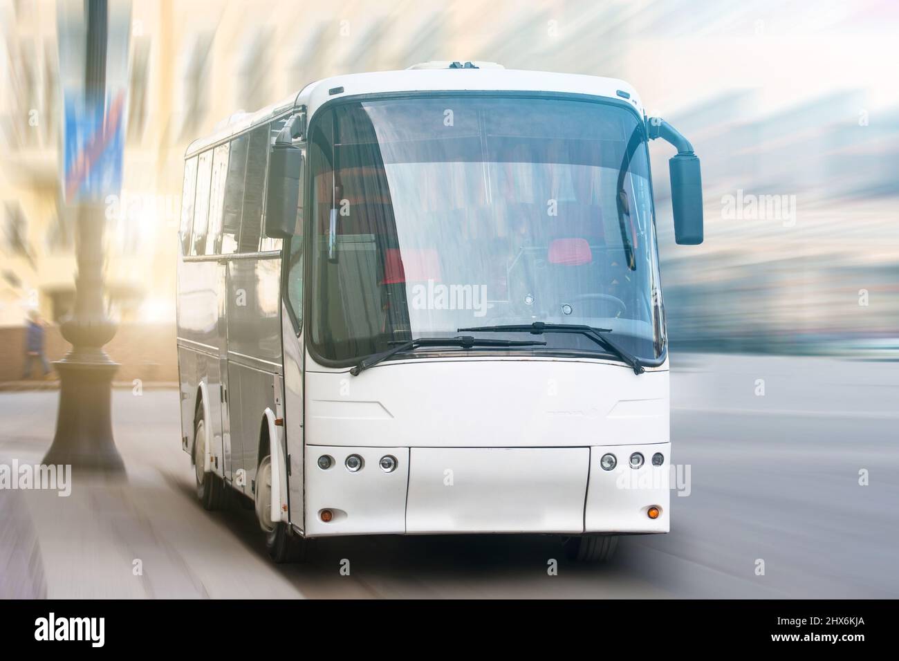 Modern transport bus on asphalt rides at high speed, front view Stock ...