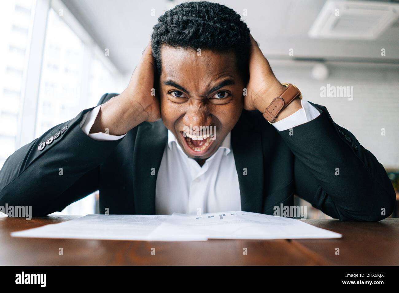 Close-up low-angle view face of troubled indignant confused African ...