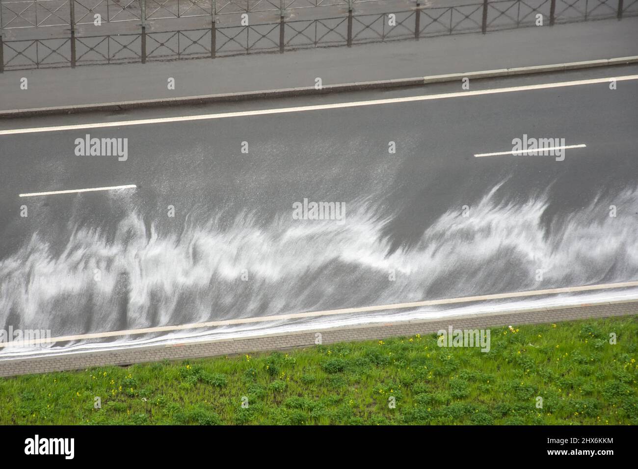View of the highway asphalt road after the rain traces of white foam ...
