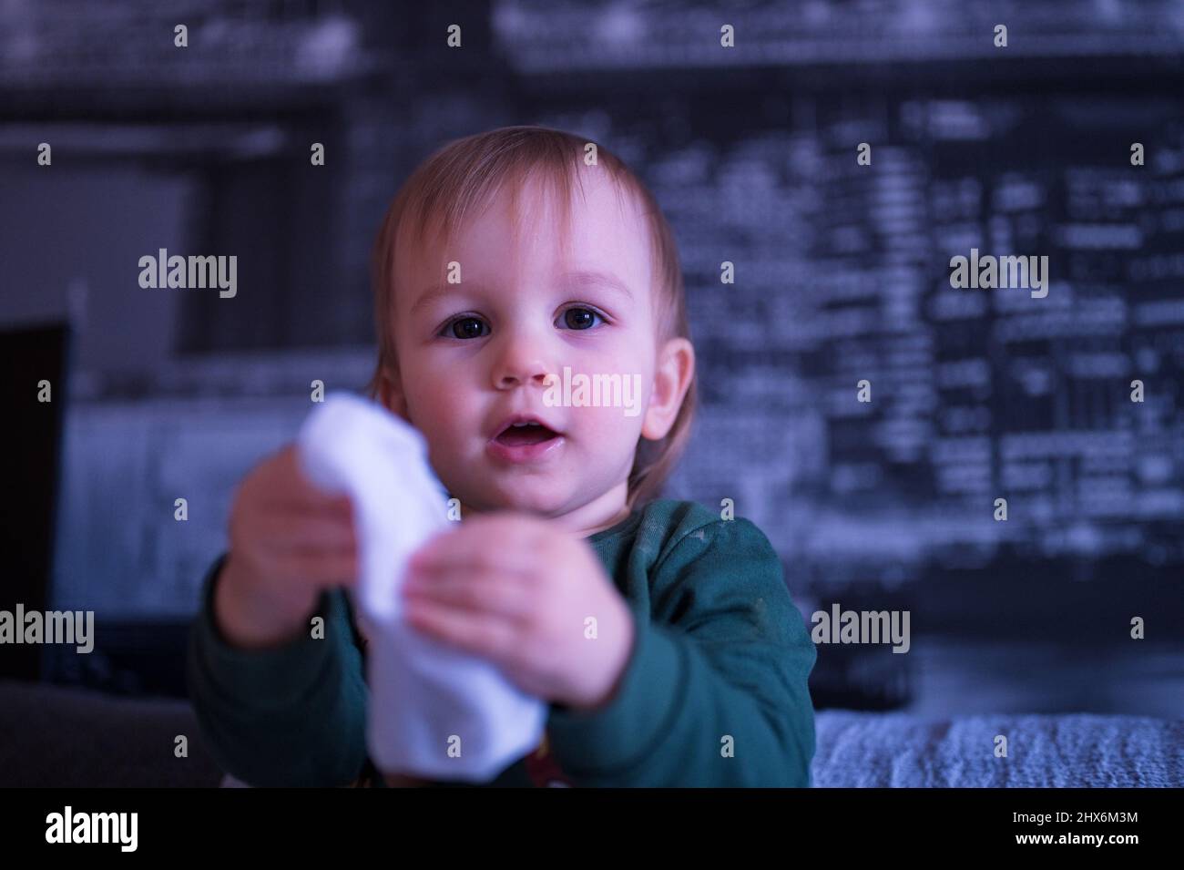Portrait of cute little boy holding wet tissue Stock Photo - Alamy