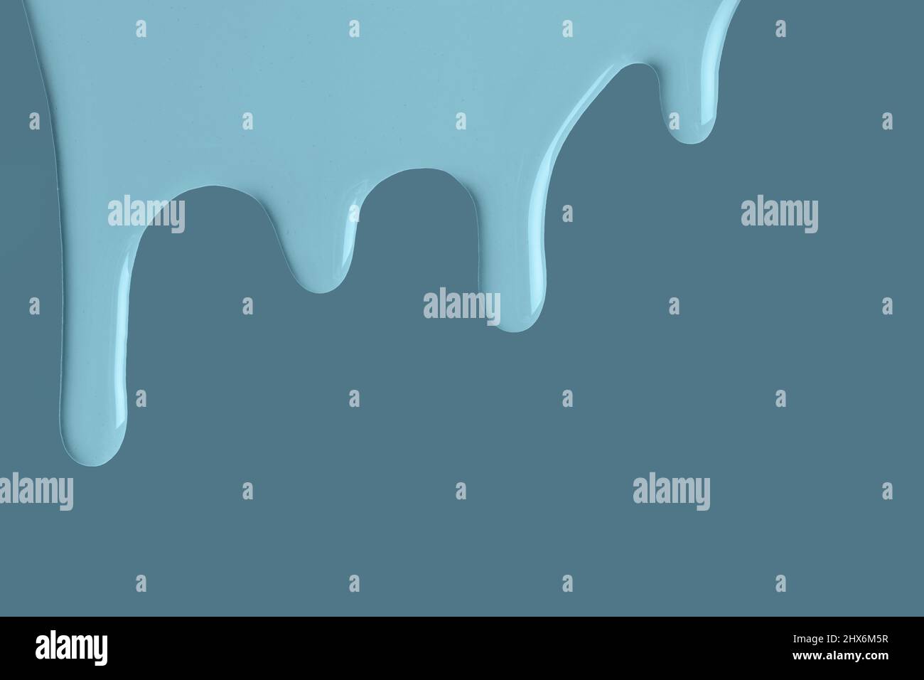 Sky liquid drops of paint color flow down on navy blue background ...