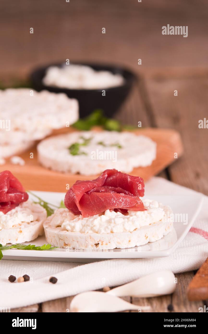Rice cakes with milk flakes and cold beef Stock Photo - Alamy