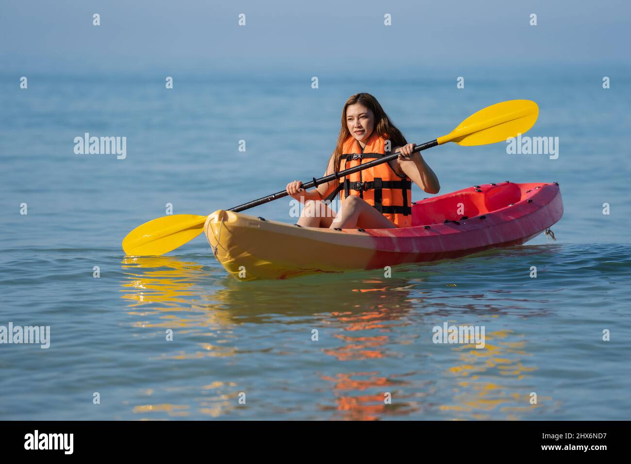 woman in life jacket paddling a kayak boat in the sea Stock Photo - Alamy