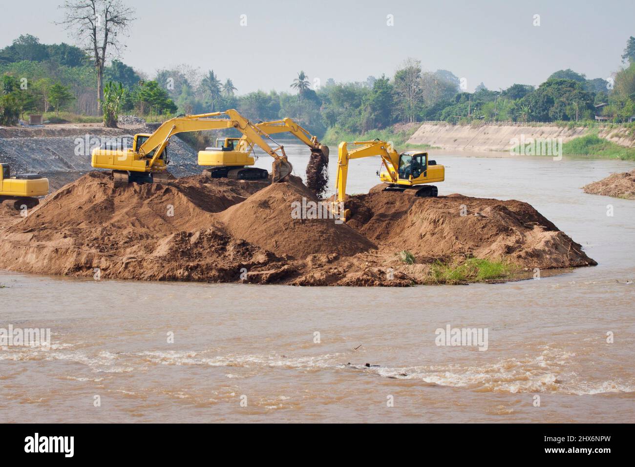 excavator machine group works at river for protect flood Stock Photo ...