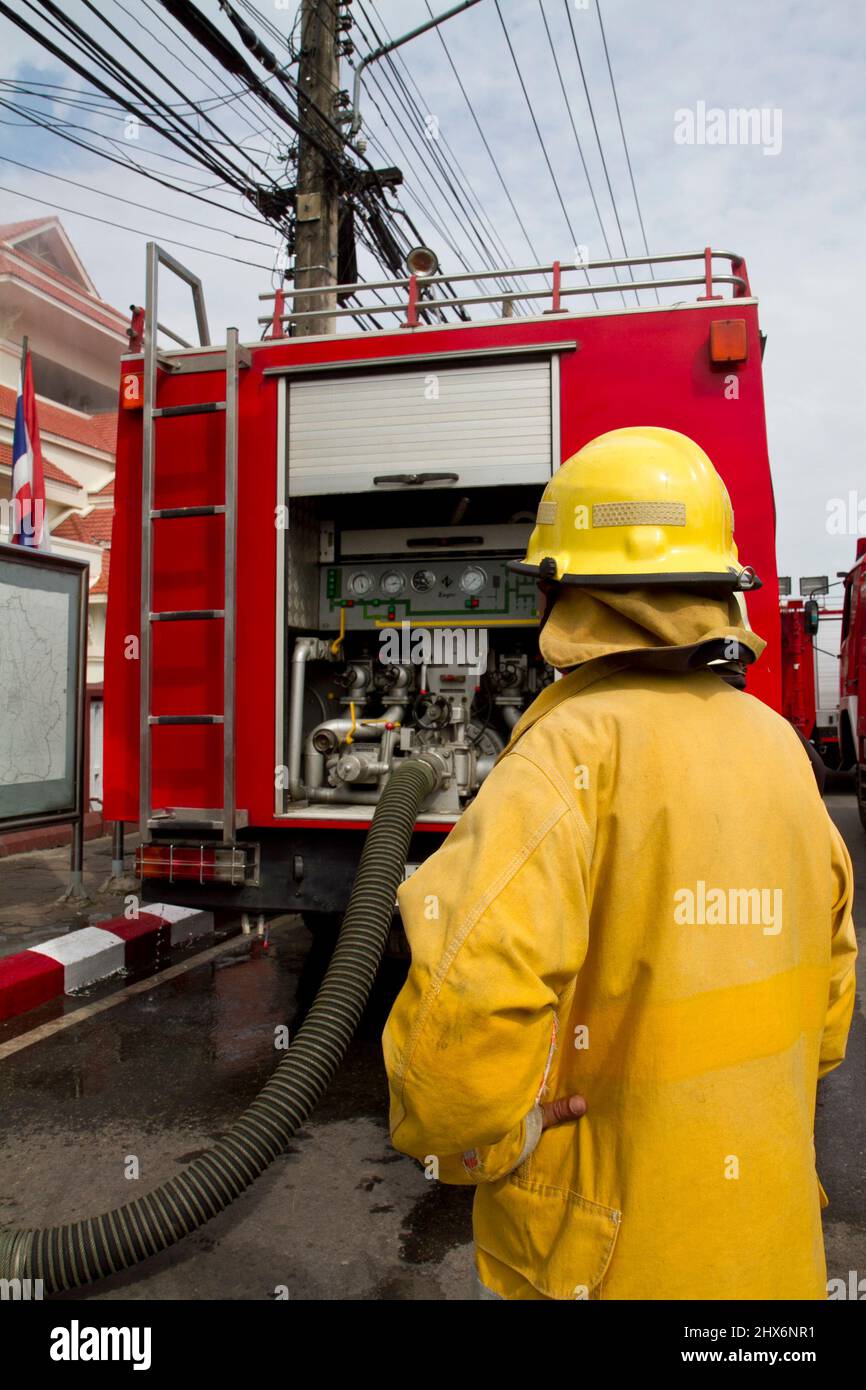 Asian Fireman with firetruck Stock Photo - Alamy