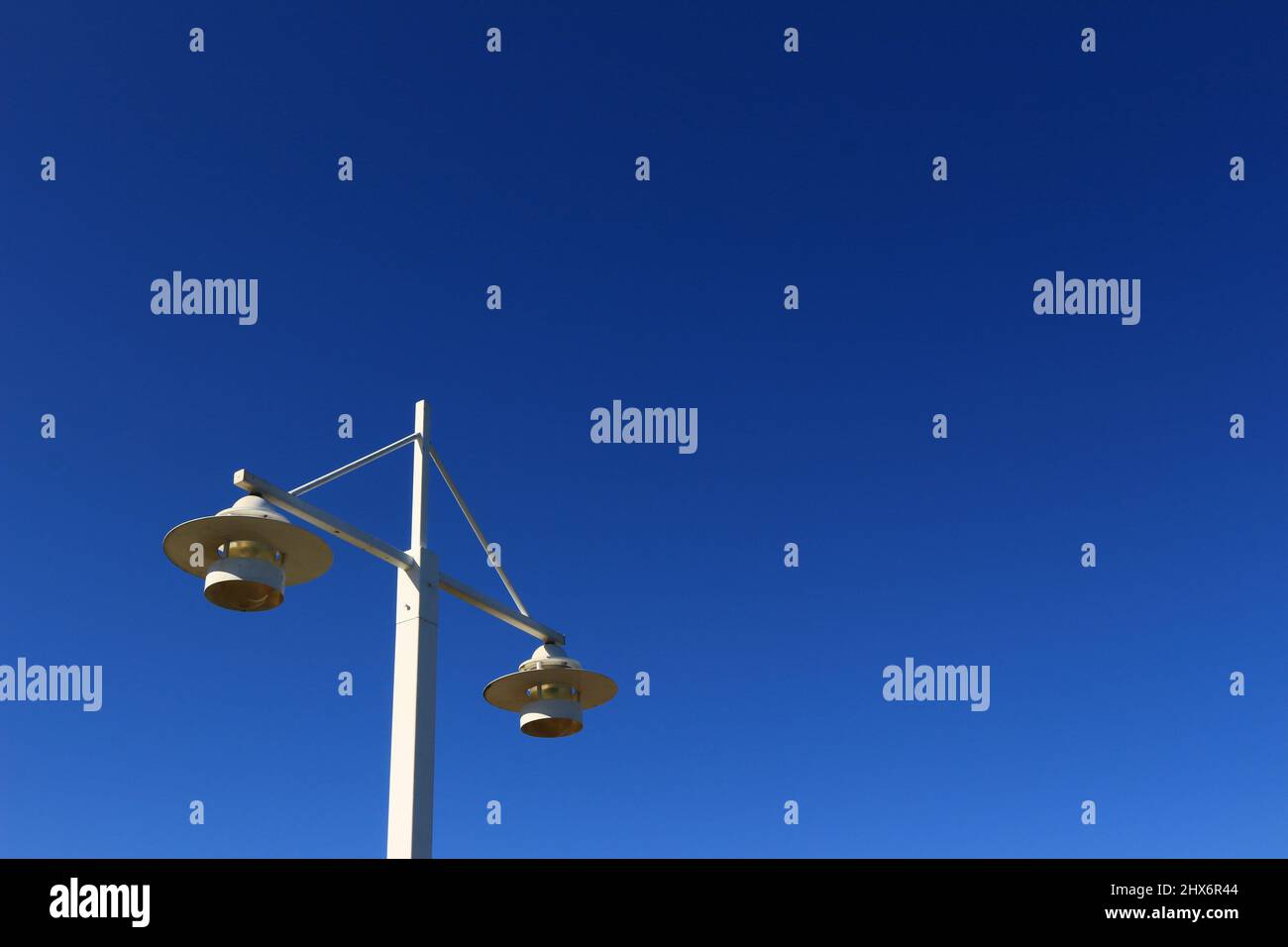 White streetlights and clear blue sky in a town by the sea Stock Photo ...