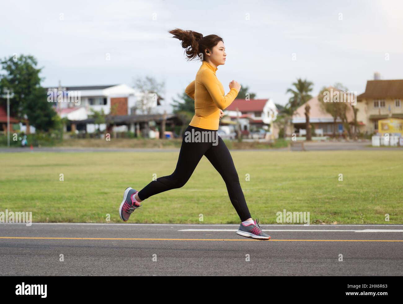 young woman running in the park in early morning Stock Photo - Alamy
