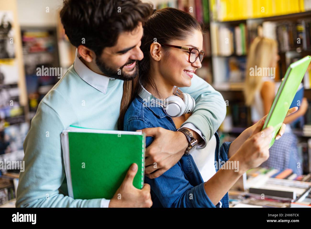 Group of happy college students studying in the school library ...