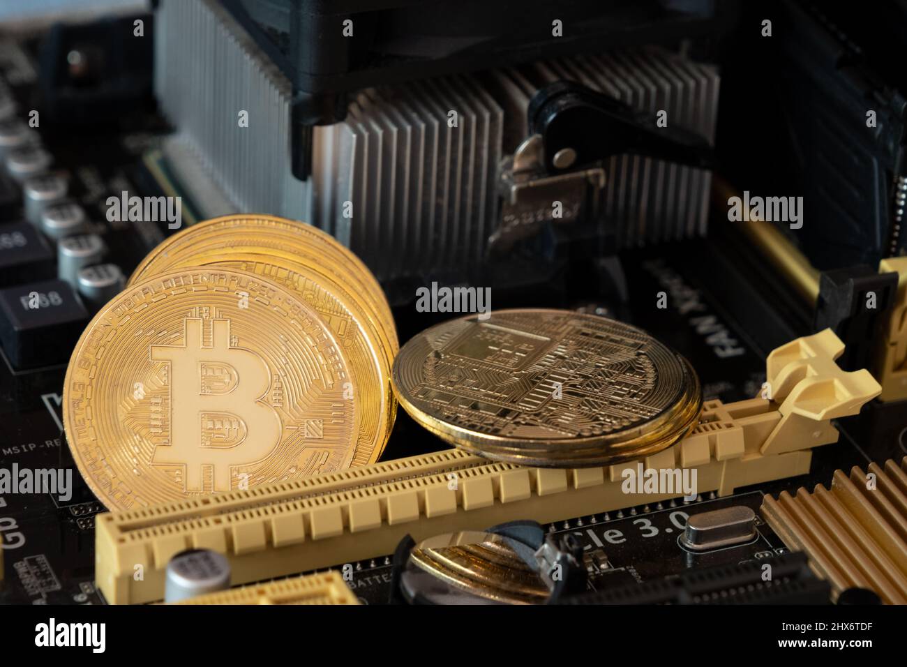 Golden bitcoins on a computer main board . Crypto currency coins on ...