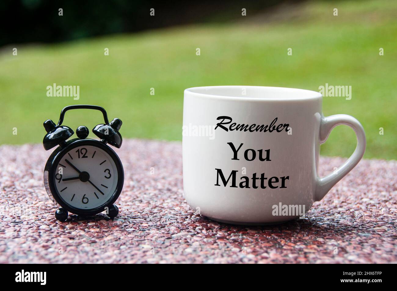 Motivational quote text on coffee cup - You matter with park and clock ...
