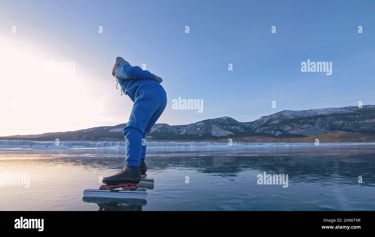 The child train on ice professional speed skating. The girl skates in ...
