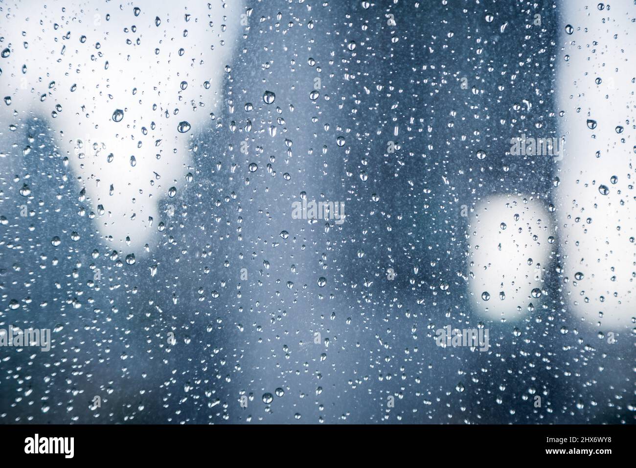 Abstract image of Rain drops on the dirty glass windows with modern ...