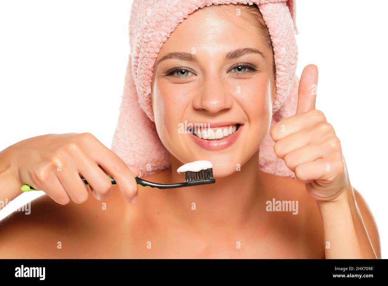 happy young woman holding toothbrushwith toothpaste on white background ...