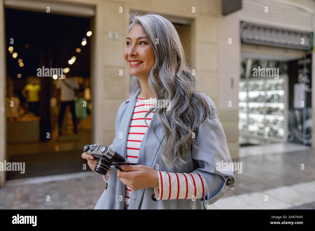 Busy mature lady taking stroll through city Stock Photo - Alamy