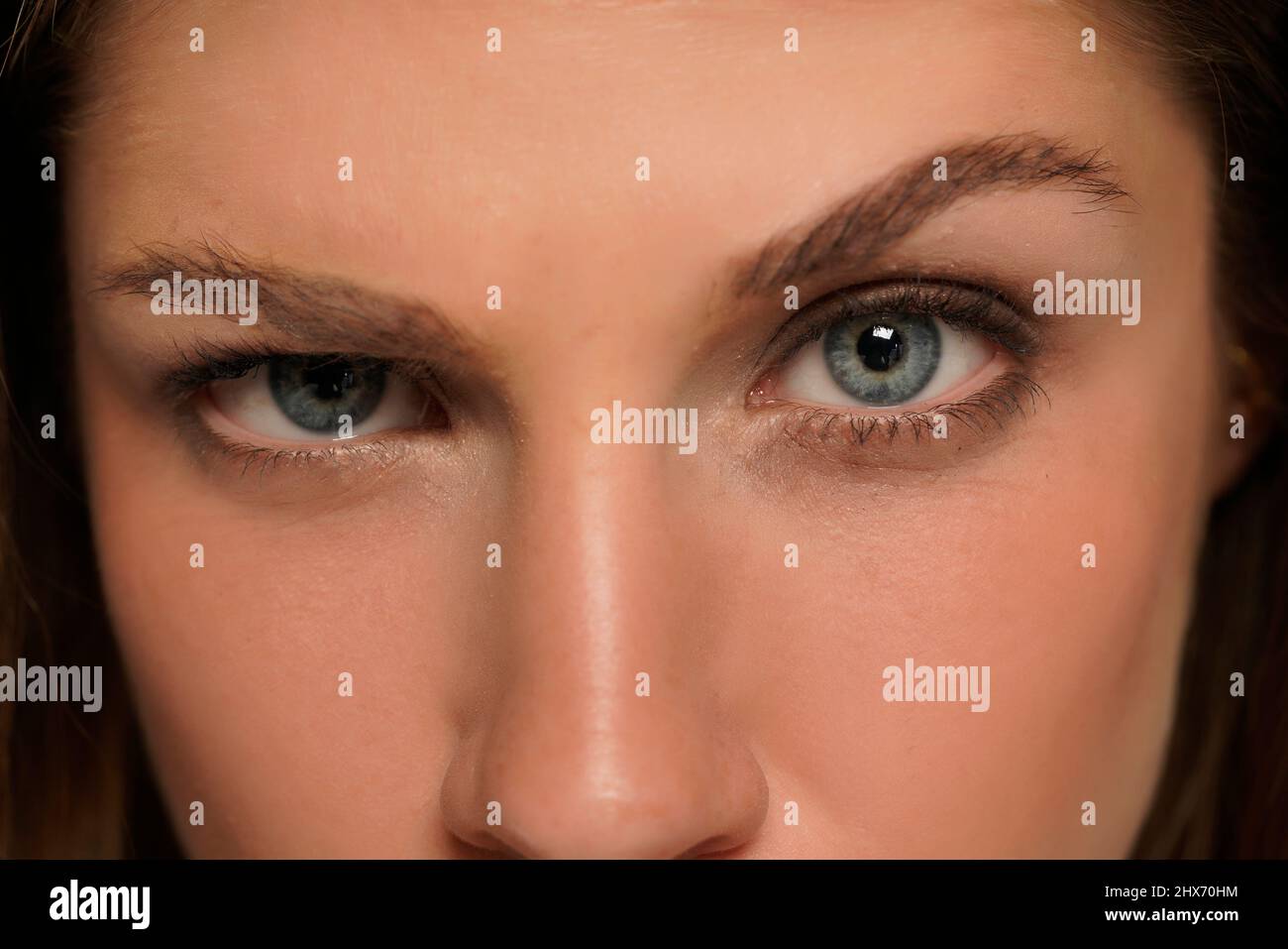 closeup female eyes look with distrust Stock Photo - Alamy