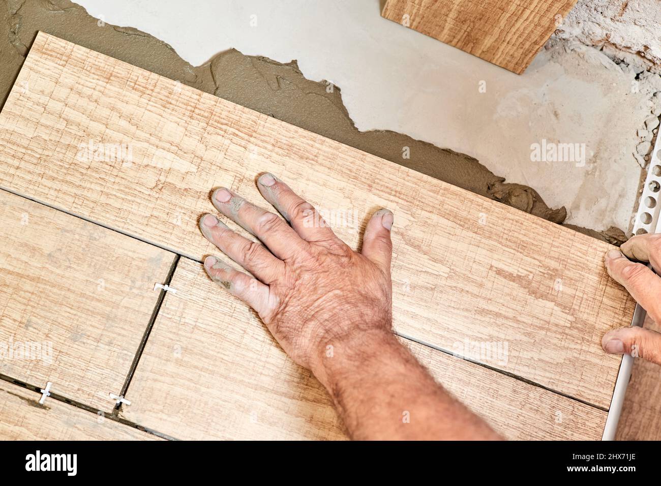 Close up laying ceramic tiles hi-res stock photography and images - Alamy