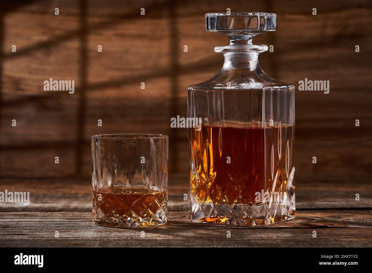 Bourbon or scotch in a classy decanter and a beautiful glass on a ...