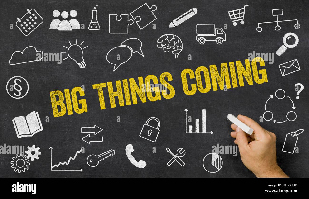 Big things coming written on a blackboard with icons Stock Photo - Alamy