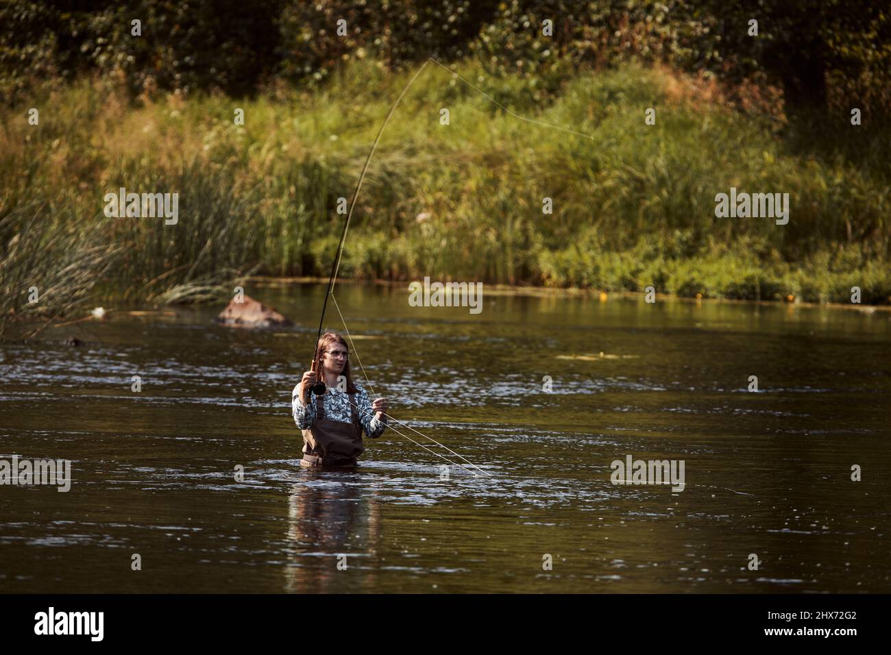Woman fly fishing standing hi-res stock photography and images - Alamy