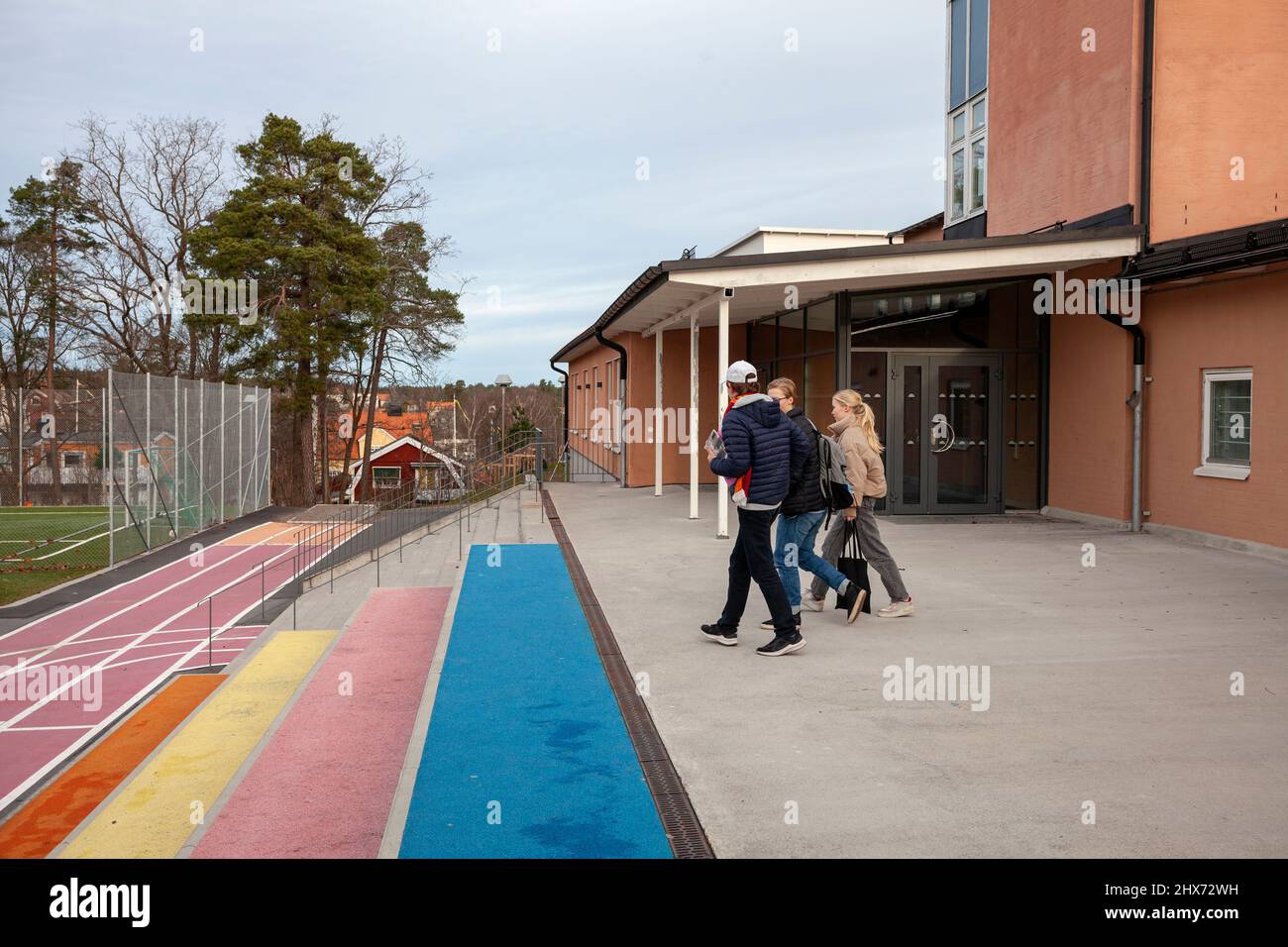 School friends walking towards school sports grounds Stock Photo - Alamy