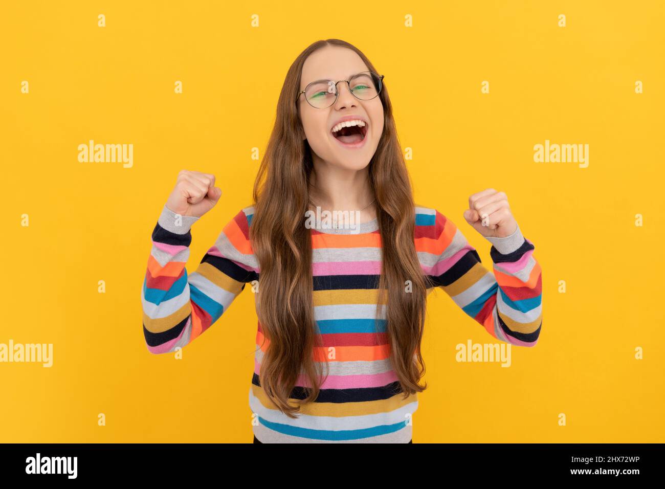 happy schoolgirl nerd teen girl in eyeglasses for vision celebrating ...