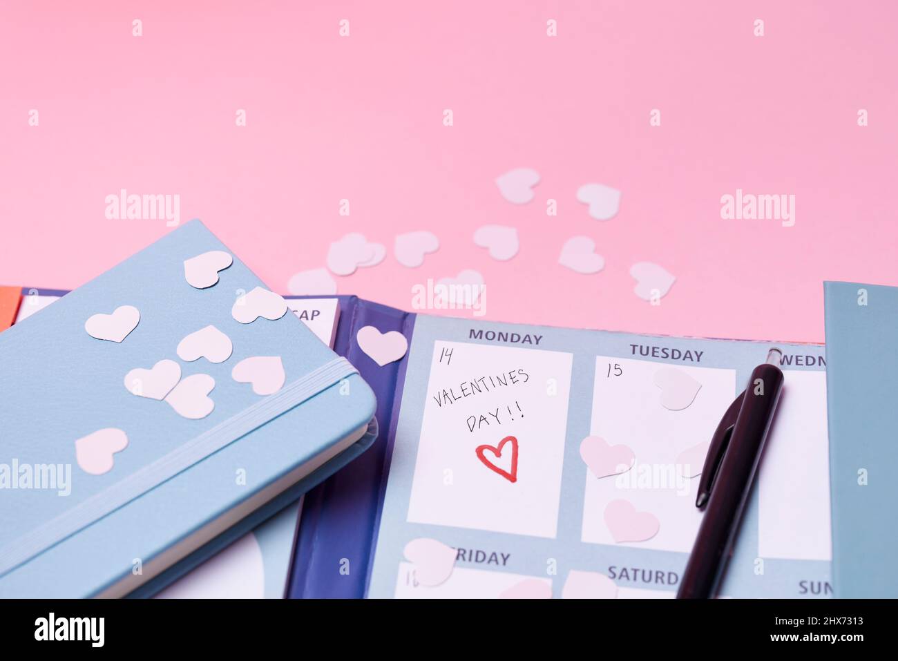 Heart-shaped confetti and calendar on pink background Stock Photo - Alamy