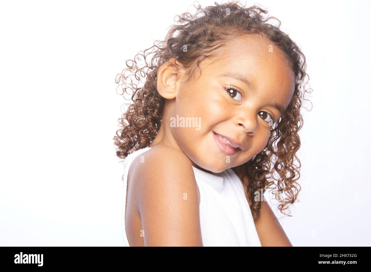 A little brown girl with brown hair, well-defined curls gesturing to ...