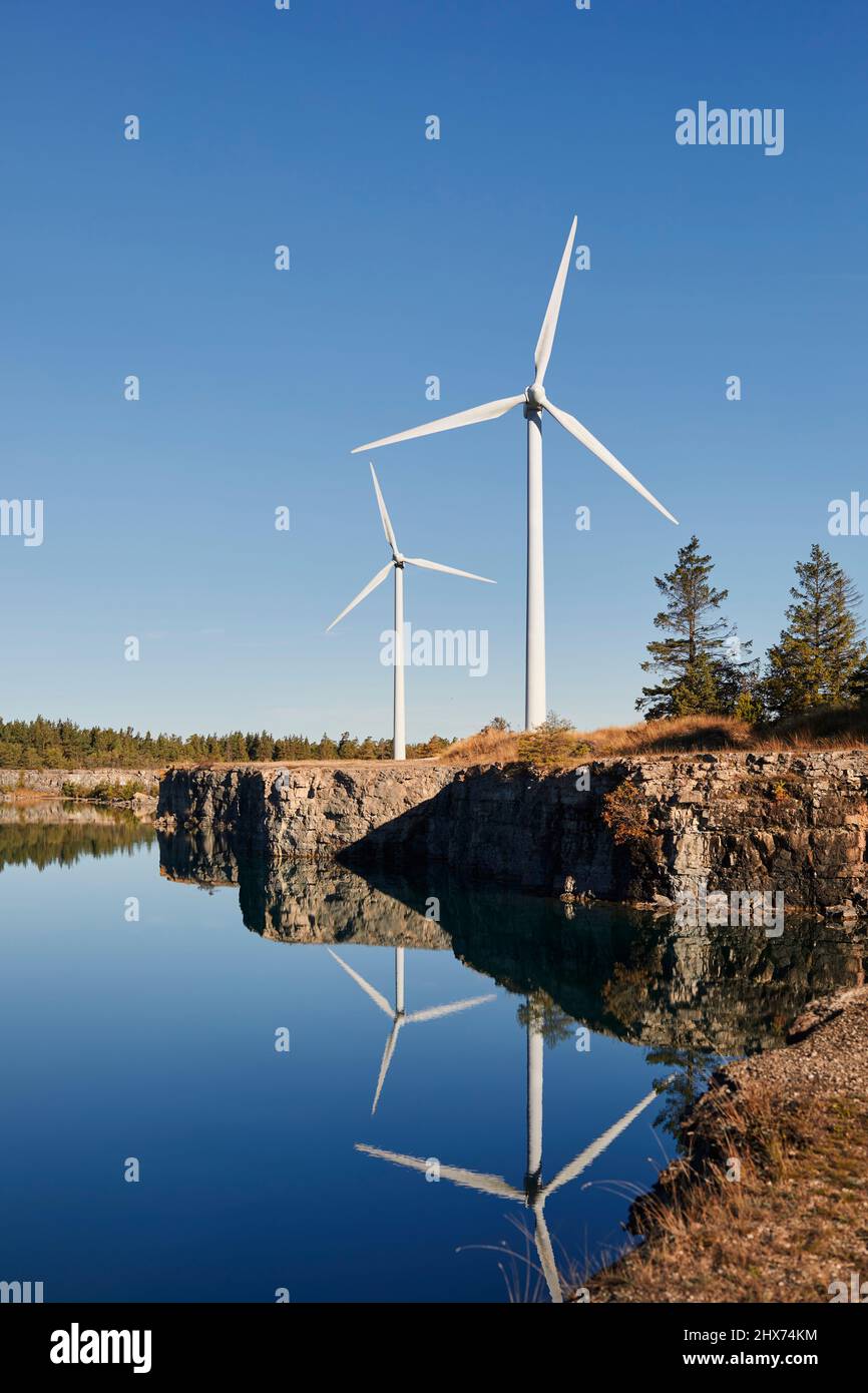View of wind turbine reflecting in water Stock Photo - Alamy