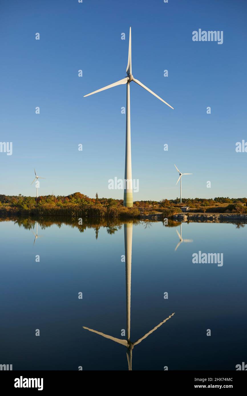 View of wind turbine reflecting in water Stock Photo - Alamy