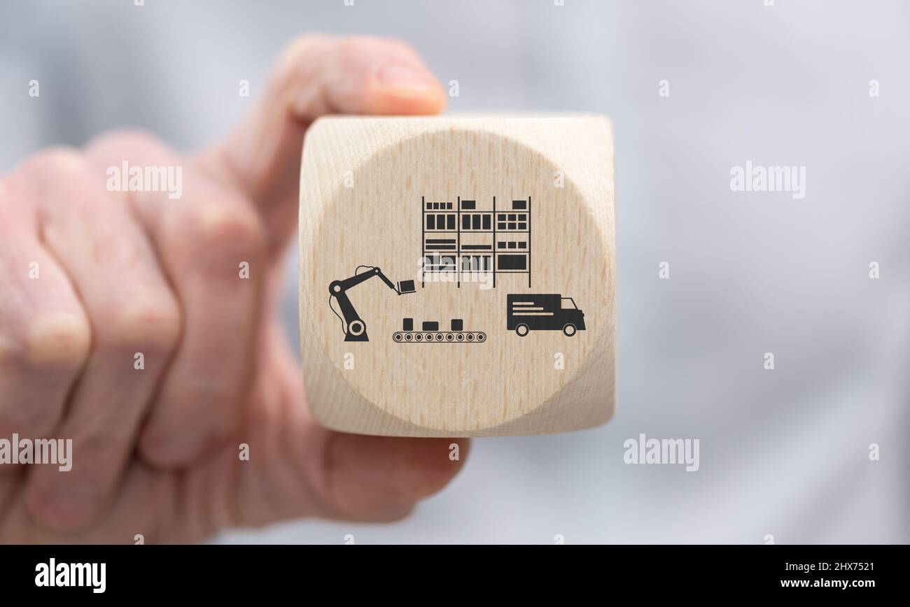 Hand holding a wooden cube with symbol of logistics concept Stock Photo ...