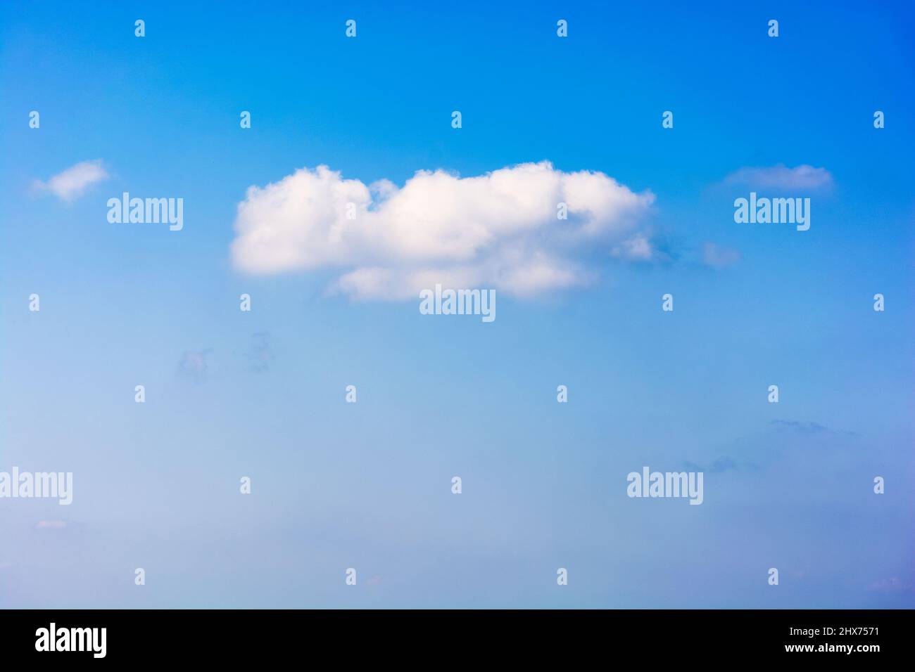 sky with fluffy clouds. white cumulus sparse cloudscape on a deep blue ...