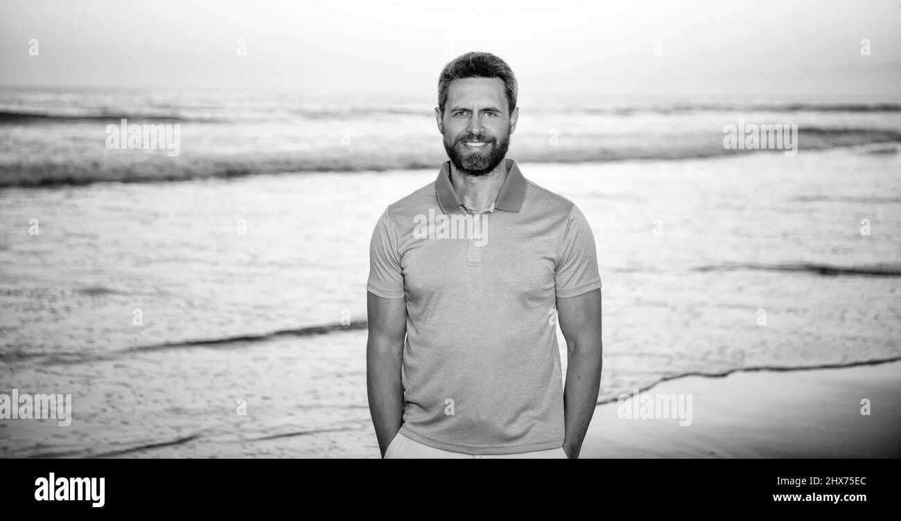 positive emotions. cheerful man with beard in sunset over sea. unshaven ...