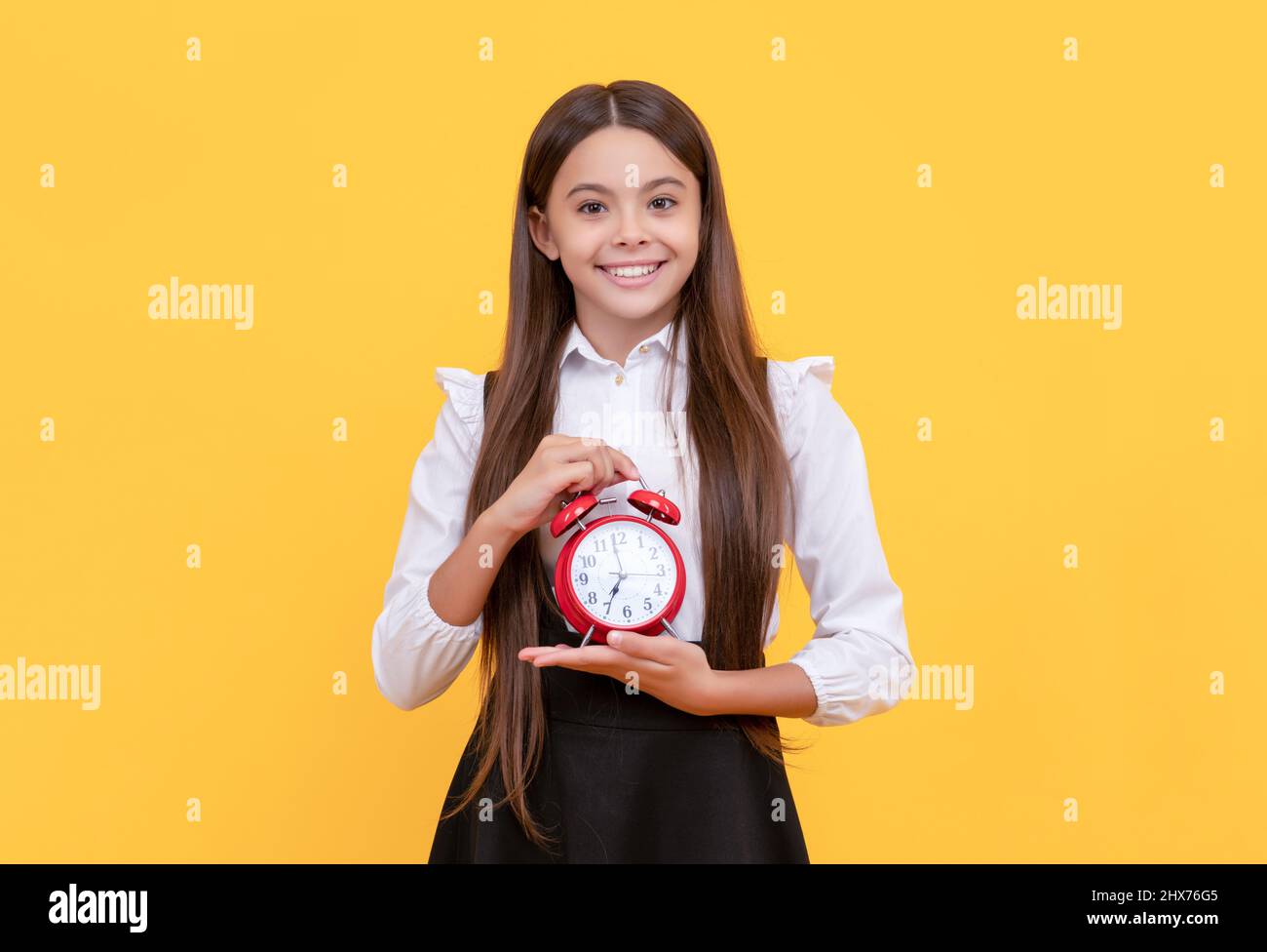 punctual teen girl checking time. happy child with alarm clock. school ...
