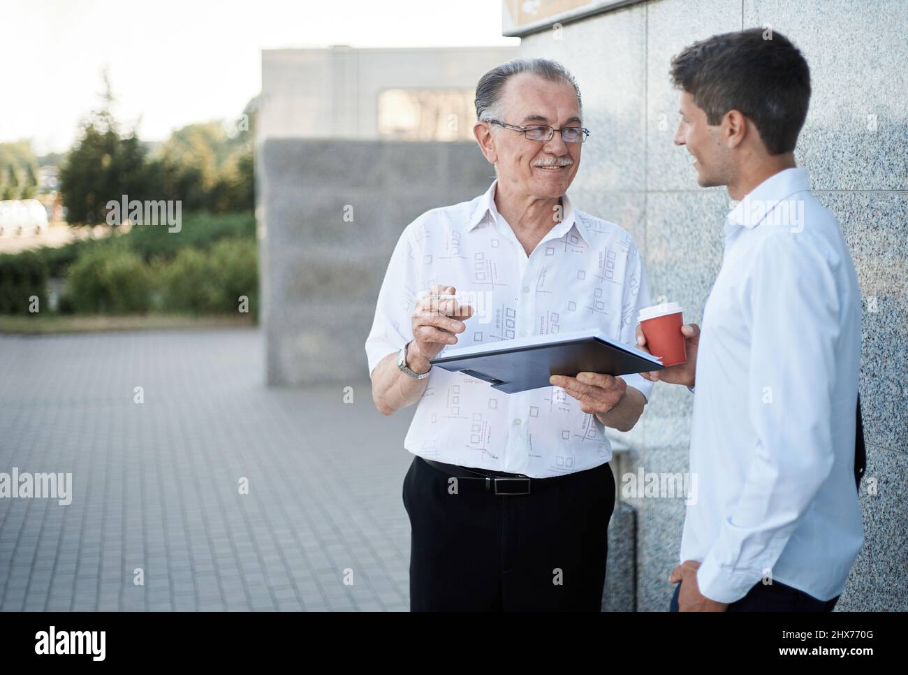 business colleagues with a digital tablet standing on the street during ...