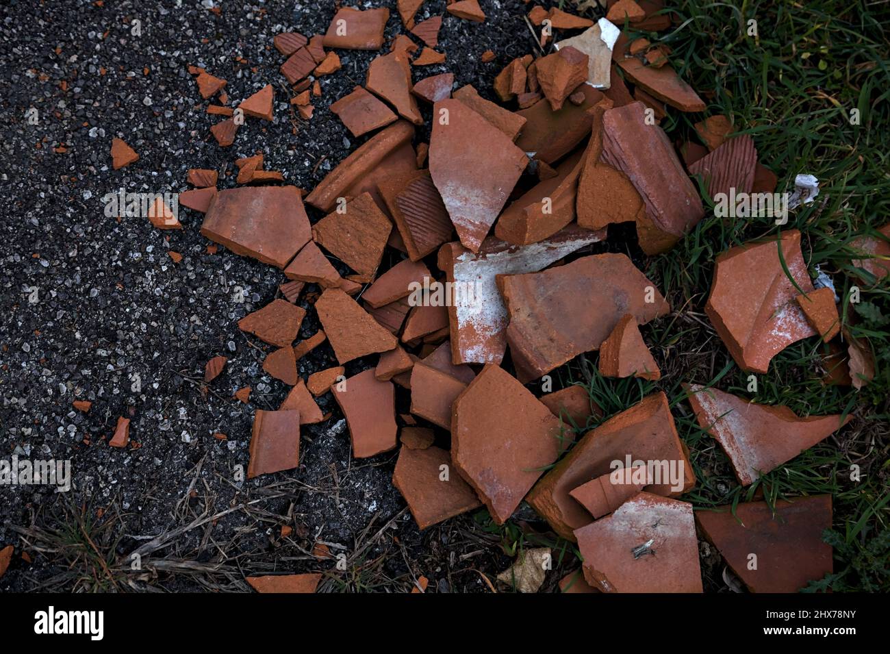 Broken roof tiles by the edge of a road Stock Photo - Alamy