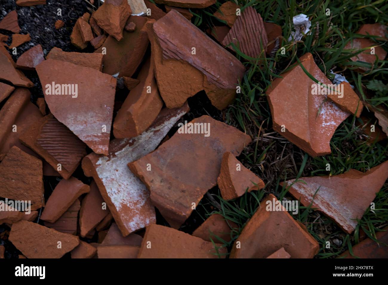 Broken roof tiles by the edge of a road Stock Photo - Alamy
