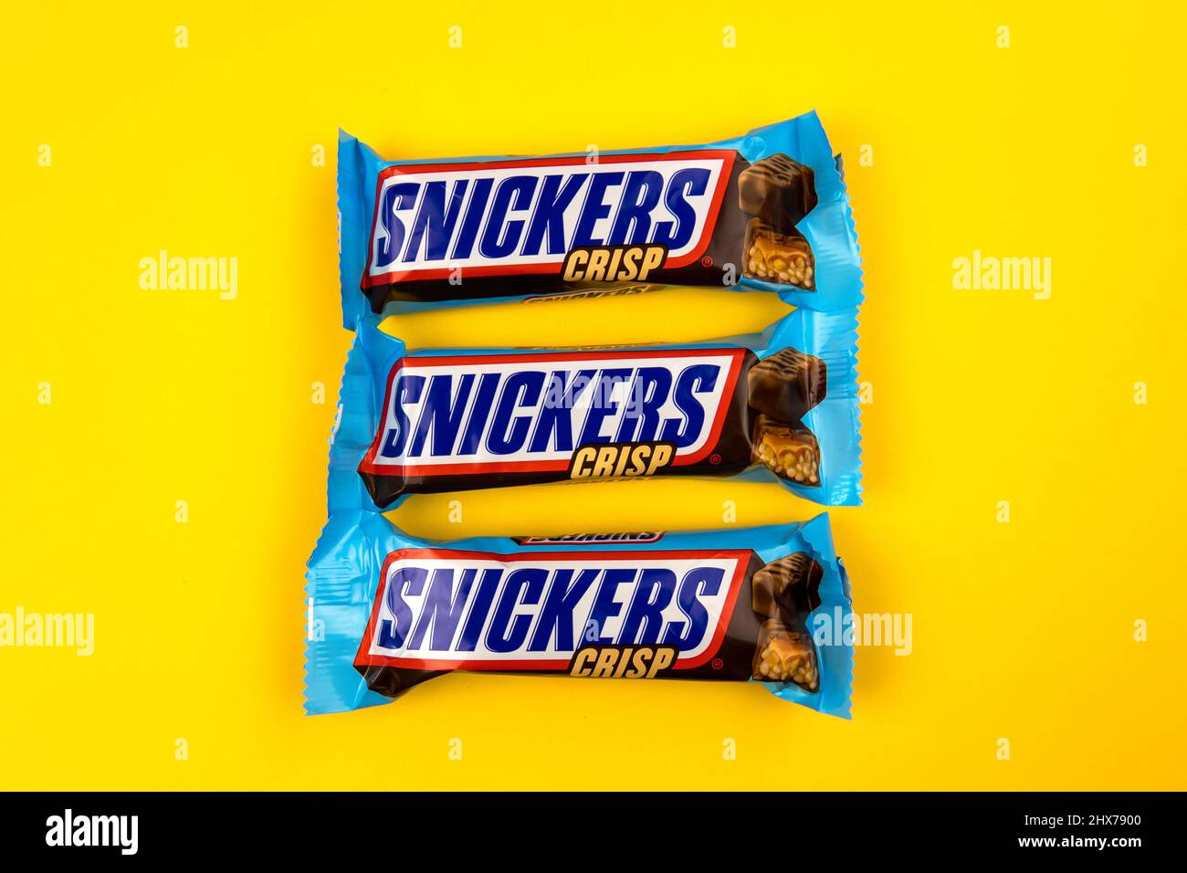 snickers crisp on a yellow background Stock Photo - Alamy