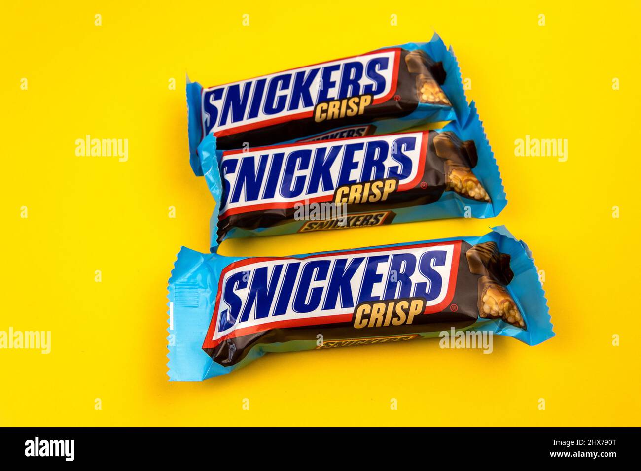 snickers crisp on a yellow background Stock Photo - Alamy