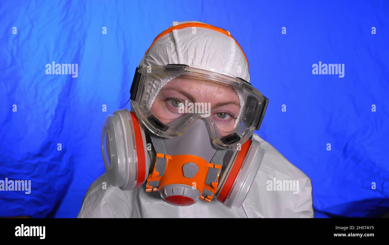 Scientist virologist in respirator. Slow motion. Woman close up look wearing protective medical ...