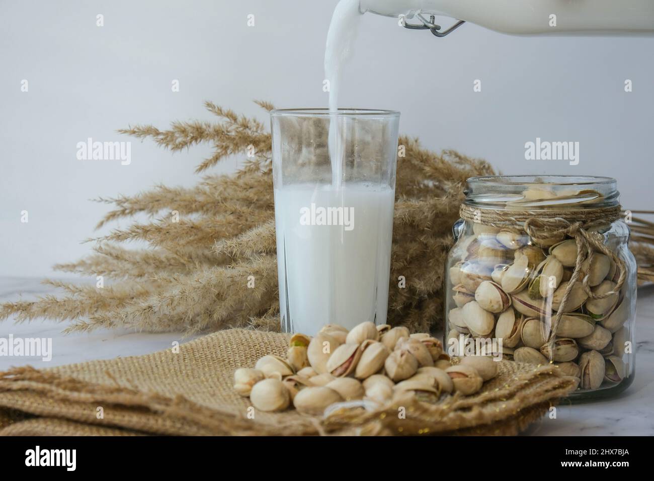 Vegetable milk is poured into a glass Pistachio lactose free milk for ...